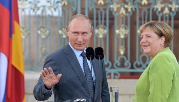 Merkel and Putin tackle tough topics in meeting outside Berlin | South ...
